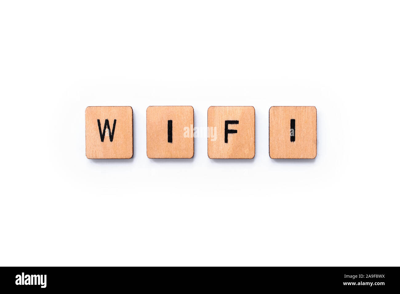 The word WIFI, spelt with wooden letter tiles over a white background ...