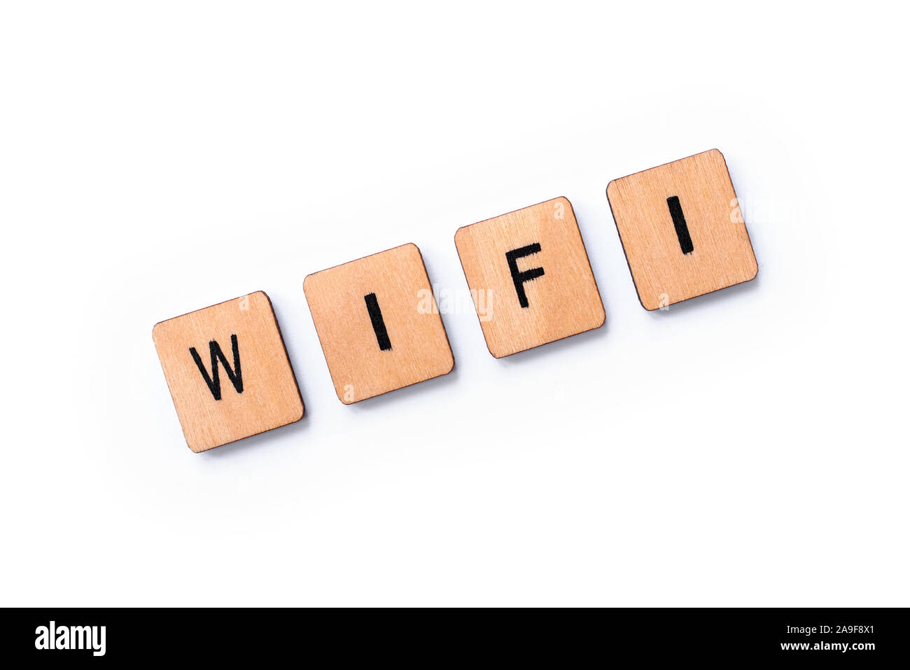 The word WIFI, spelt with wooden letter tiles over a white background ...