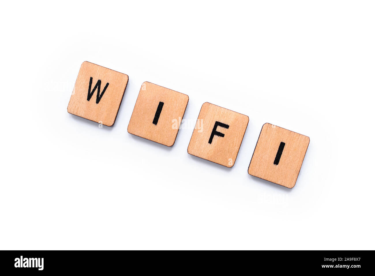 The word WIFI, spelt with wooden letter tiles over a white background ...