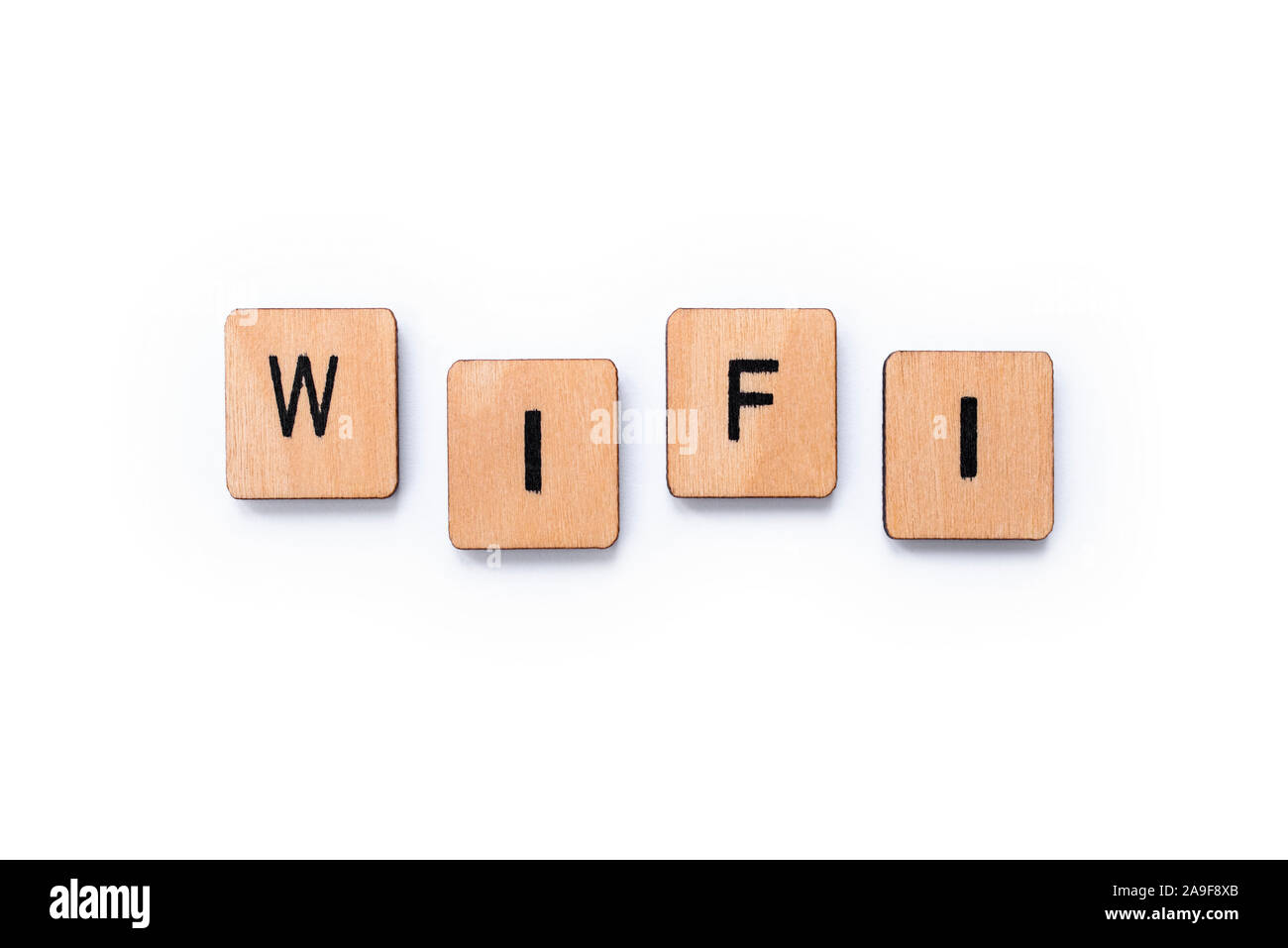 The word WIFI, spelt with wooden letter tiles over a white background ...
