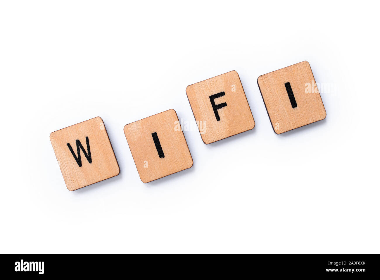 The word WIFI, spelt with wooden letter tiles over a white background ...
