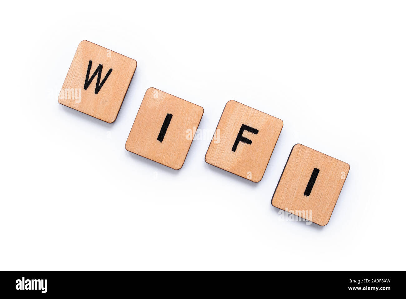 The word WIFI, spelt with wooden letter tiles over a white background ...