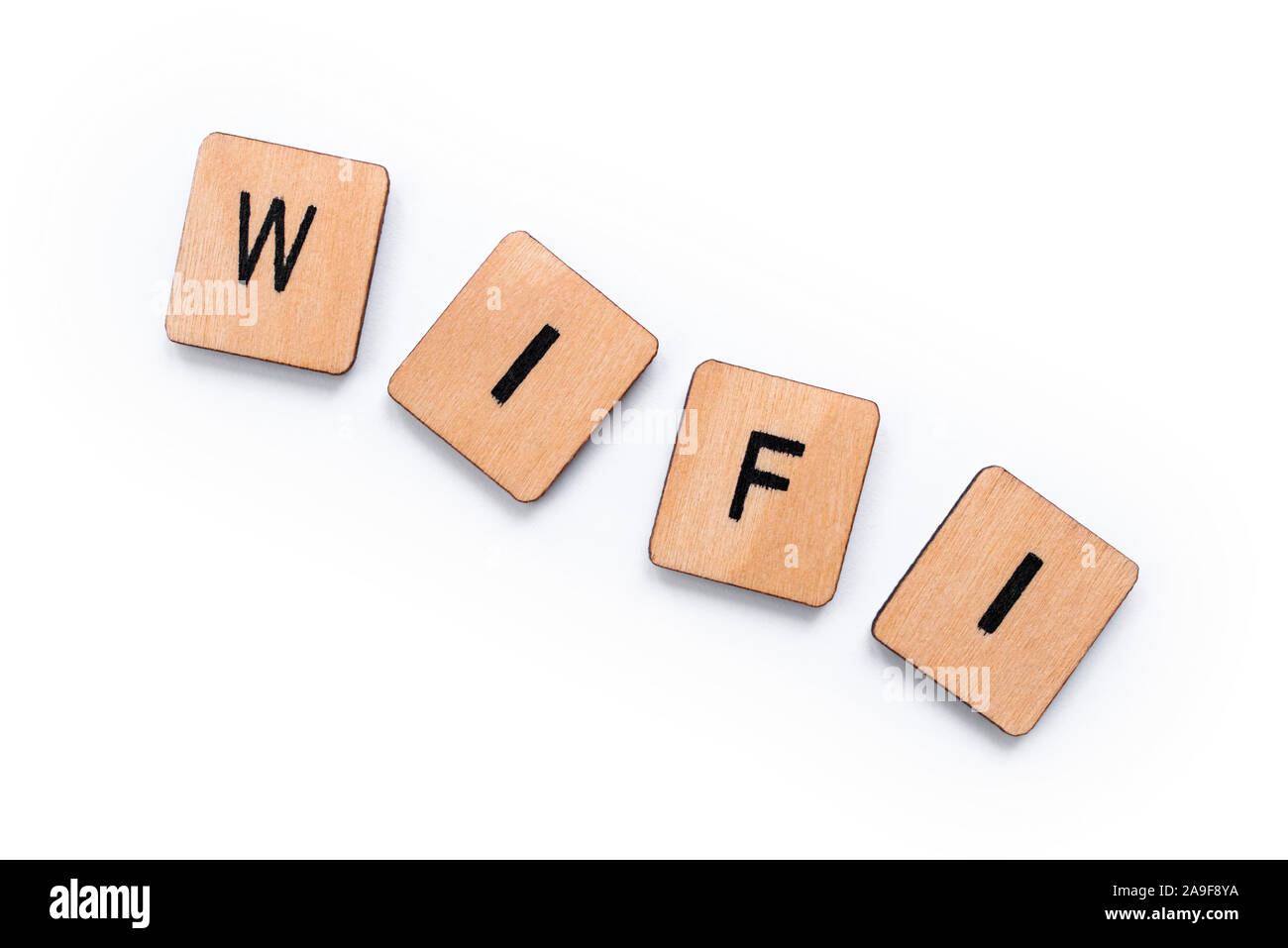 The word WIFI, spelt with wooden letter tiles over a white background ...