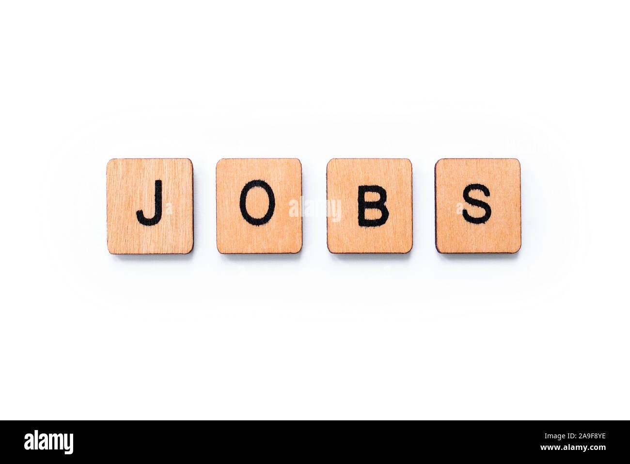 The word JOBS, spelt with wooden letter tiles over a white background ...