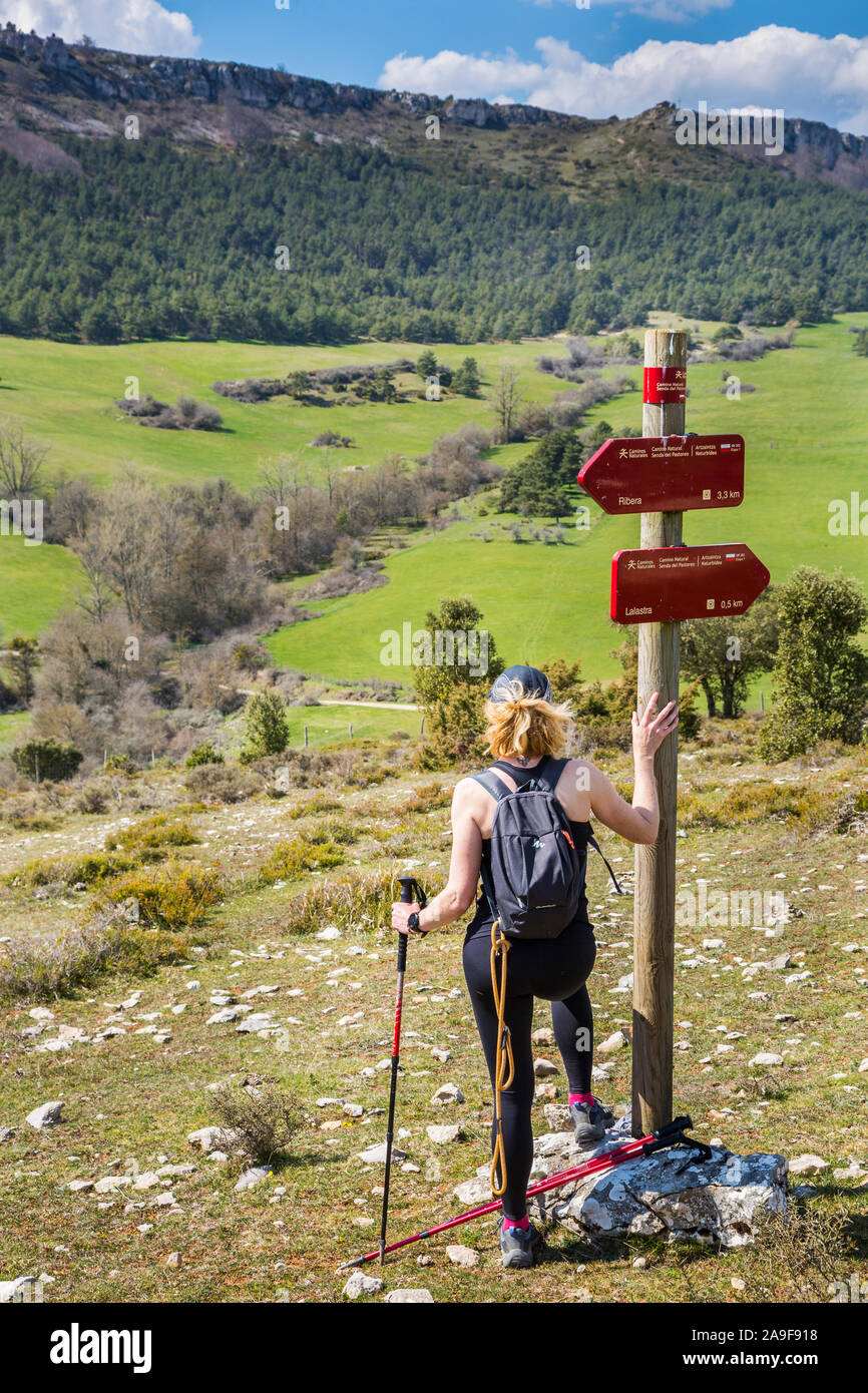 Woman hiker and signs Stock Photo - Alamy