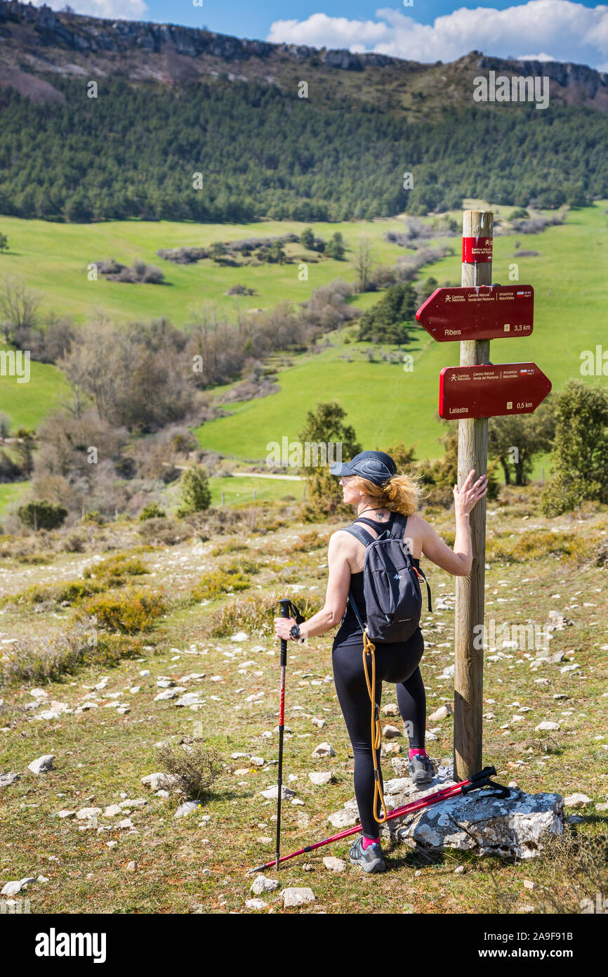 Woman hiker and signs Stock Photo - Alamy