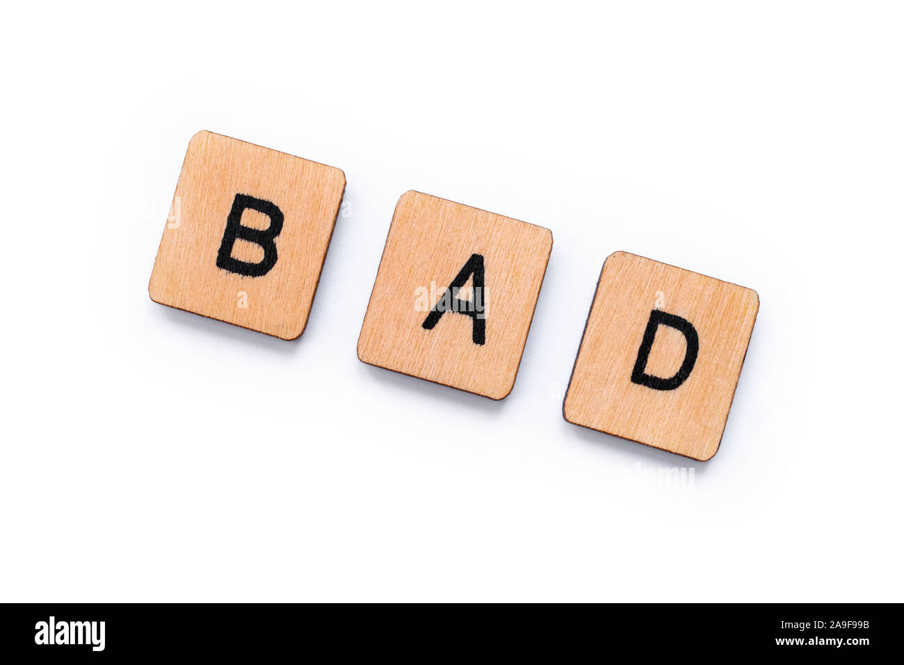 The word BAD, spelt with wooden letter tiles over a white background ...