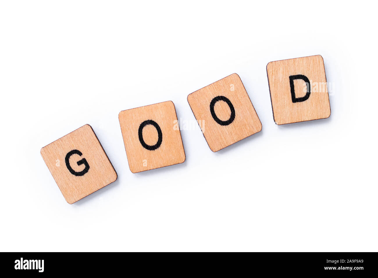 The word GOOD, spelt with wooden letter tiles over a white background ...