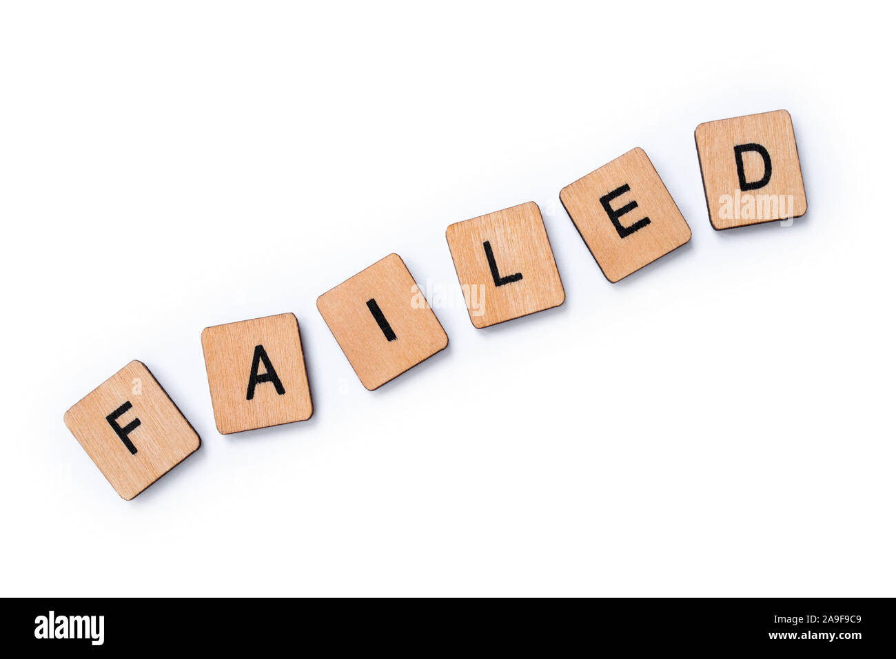 The word FAILED, spelt with wooden letter tiles over a white background ...