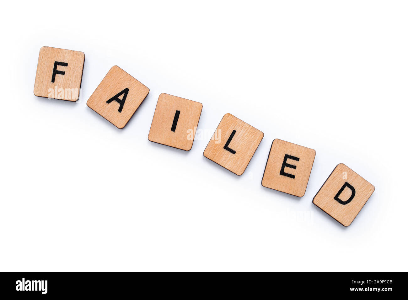 The word FAILED, spelt with wooden letter tiles over a white background ...