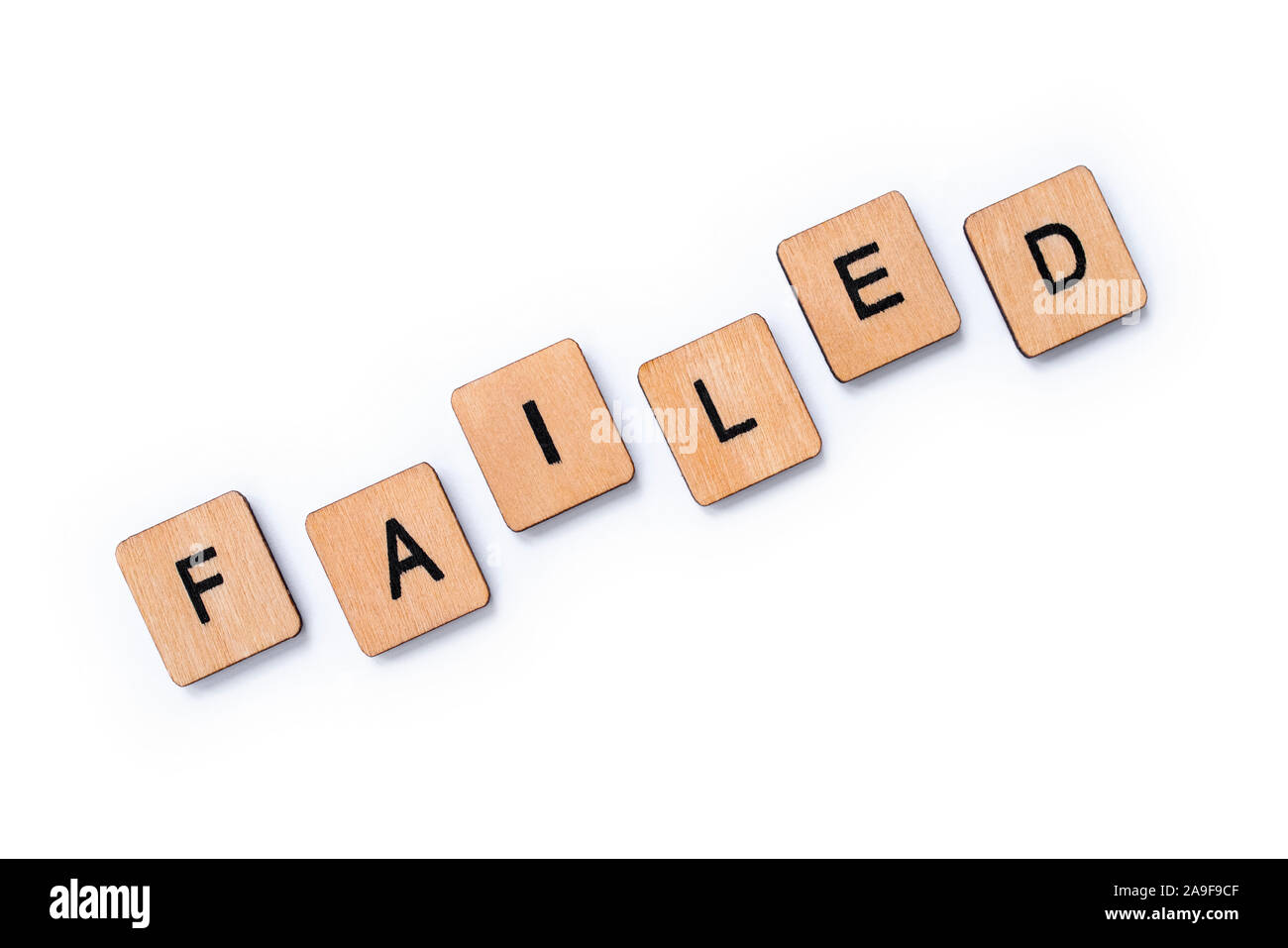 The word FAILED, spelt with wooden letter tiles over a white background ...