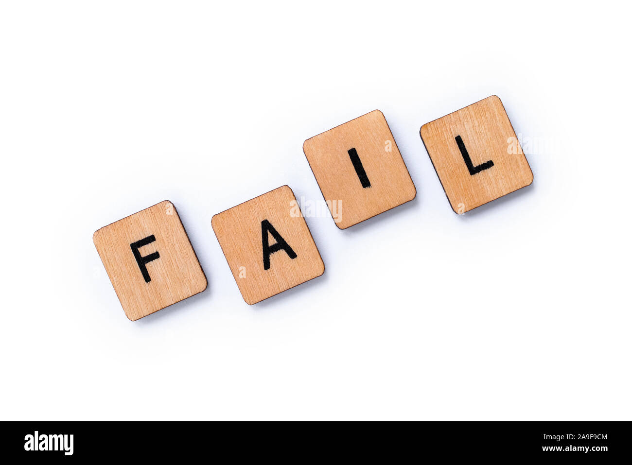 The word FAIL, spelt with wooden letter tiles over a white background ...