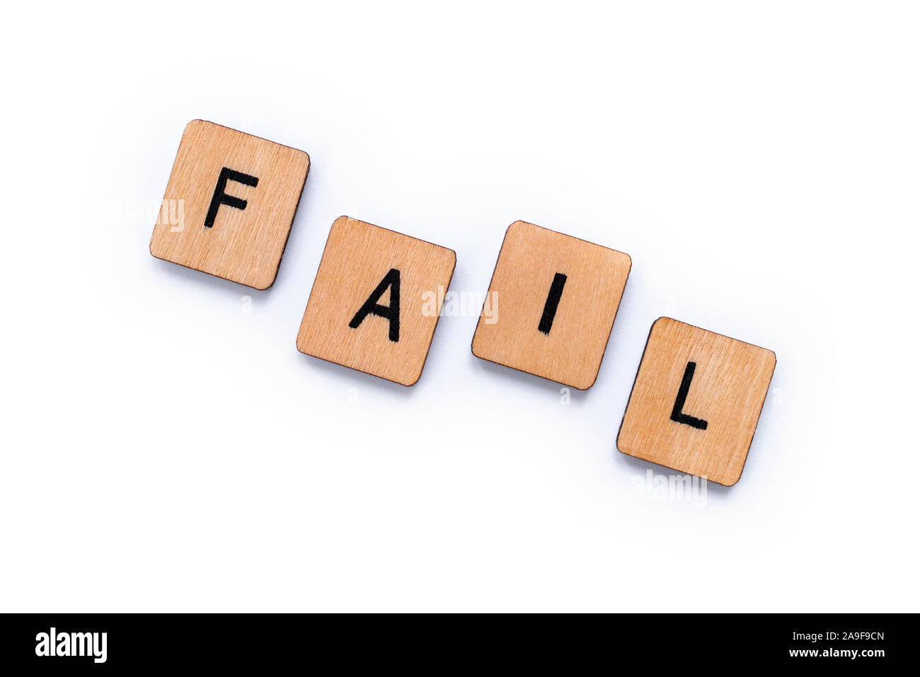 The word FAIL, spelt with wooden letter tiles over a white background ...