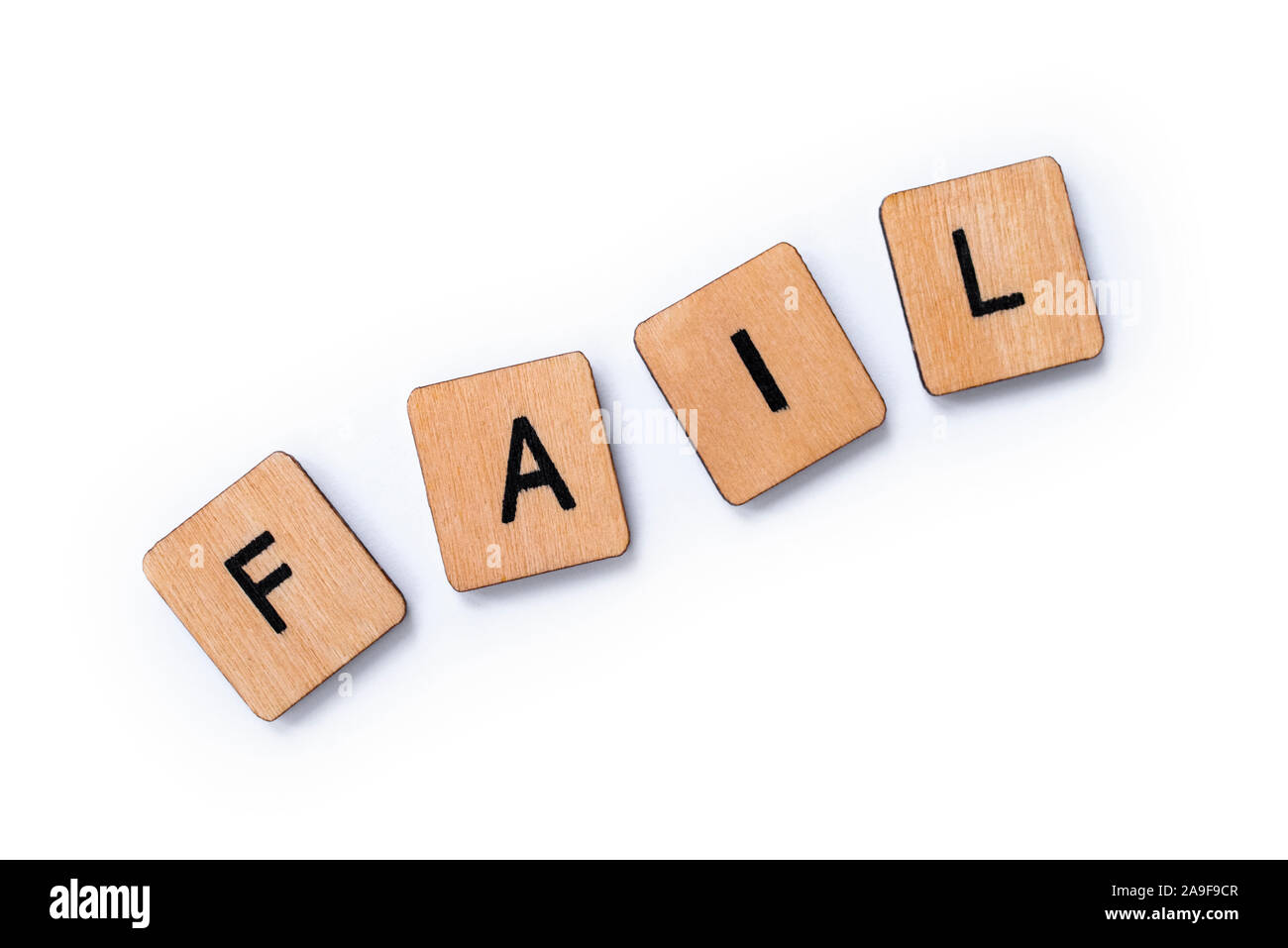 The word FAIL, spelt with wooden letter tiles over a white background ...