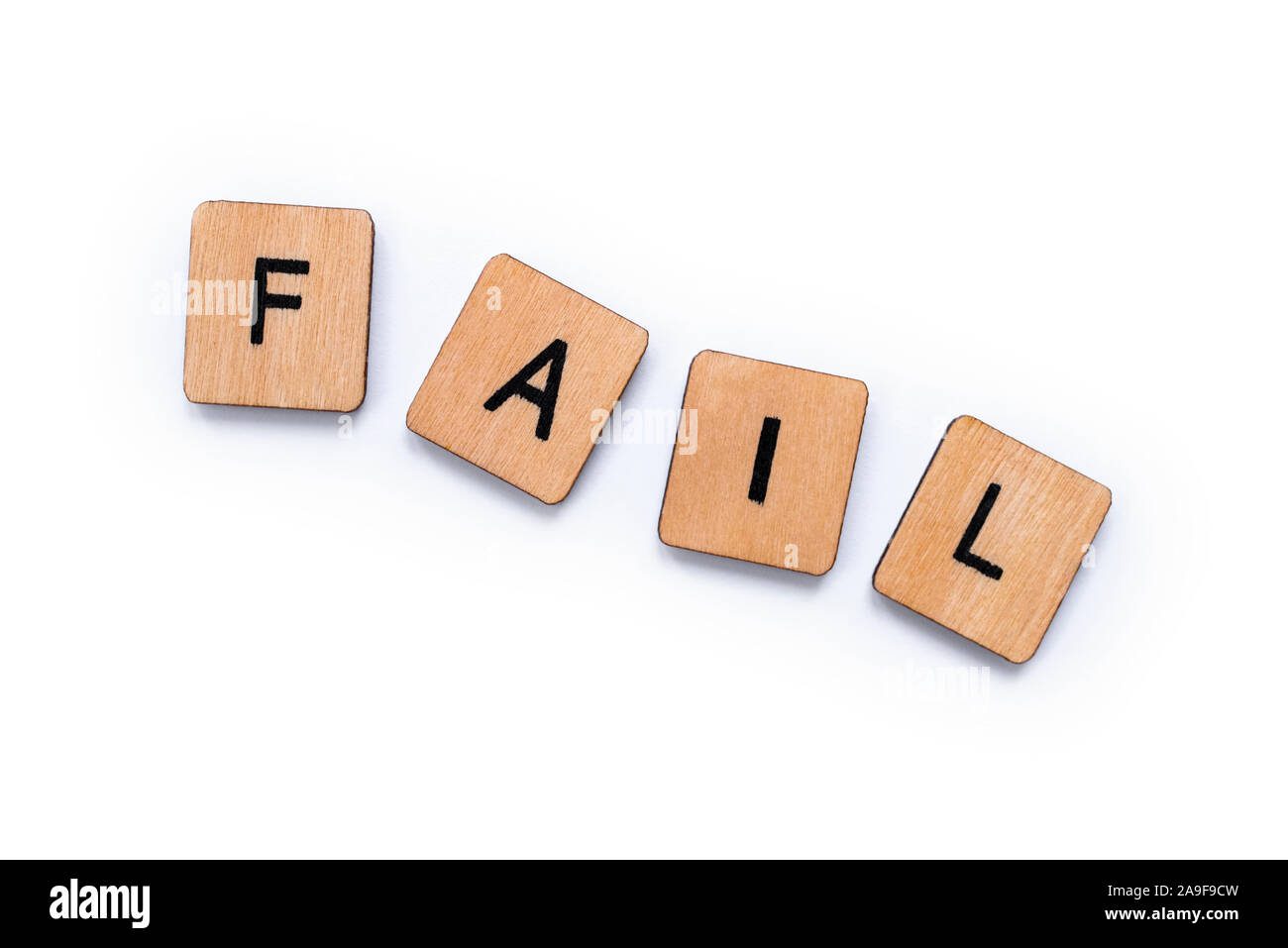 The word FAIL, spelt with wooden letter tiles over a white background ...