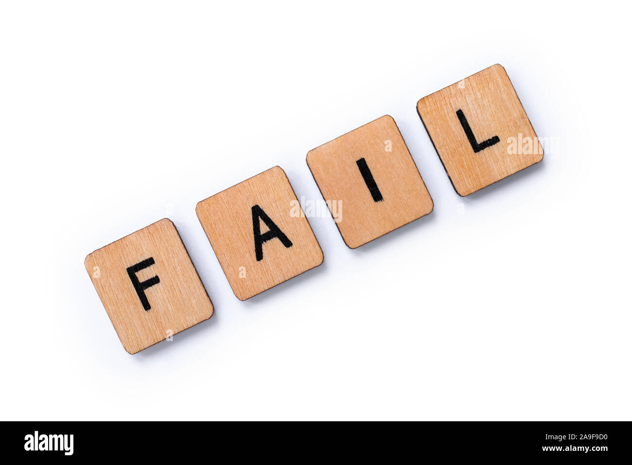The word FAIL, spelt with wooden letter tiles over a white background ...
