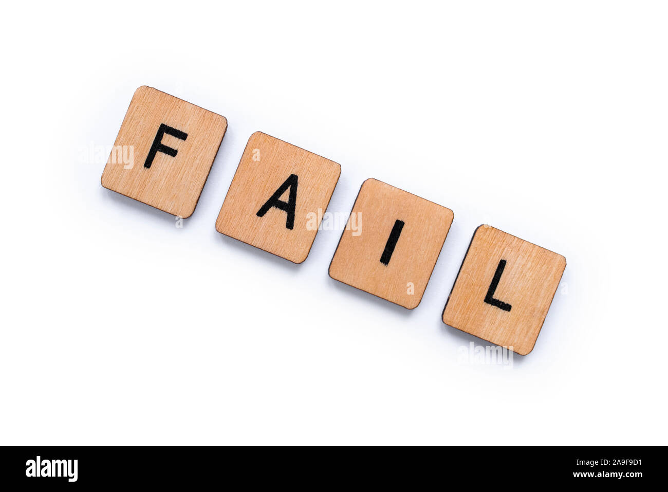 The word FAIL, spelt with wooden letter tiles over a white background ...