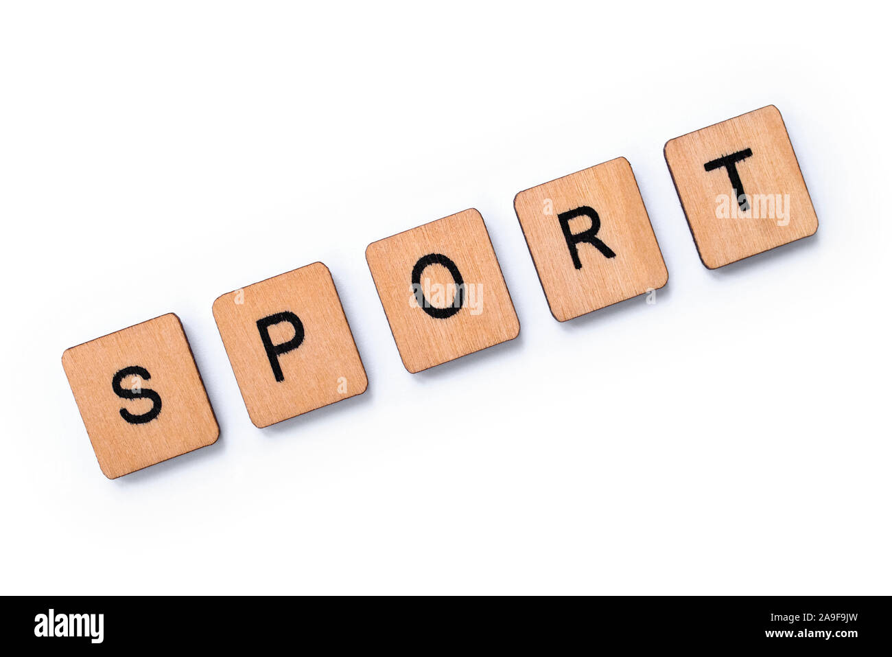The word SPORT, spelt with wooden letter tiles over a white background ...