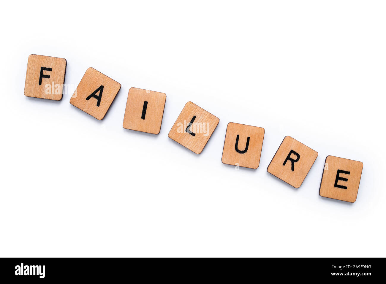 The word FAILURE, spelt with wooden letter tiles over a white ...