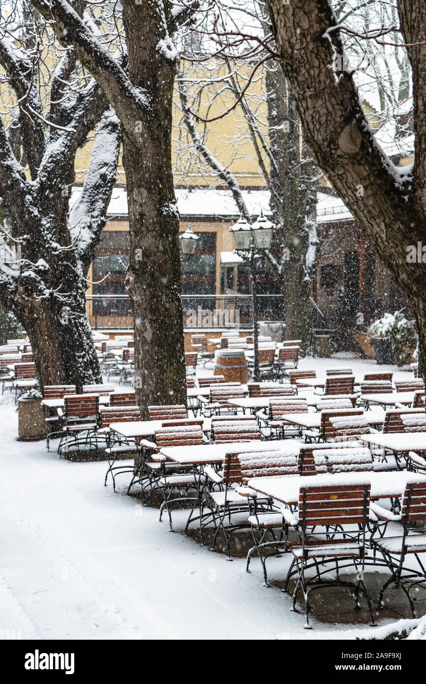 Outdoor cafe without visitors under falling snow Stock Photo - Alamy