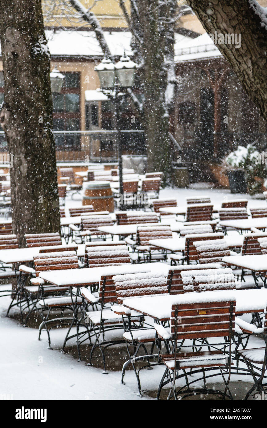 Outdoor cafe without visitors under falling snow Stock Photo - Alamy