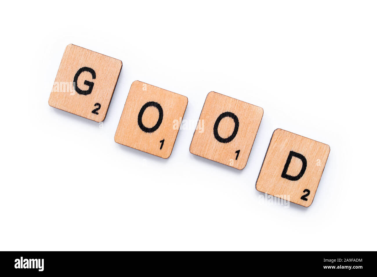 The word GOOD, spelt with wooden letter tiles over a white background ...