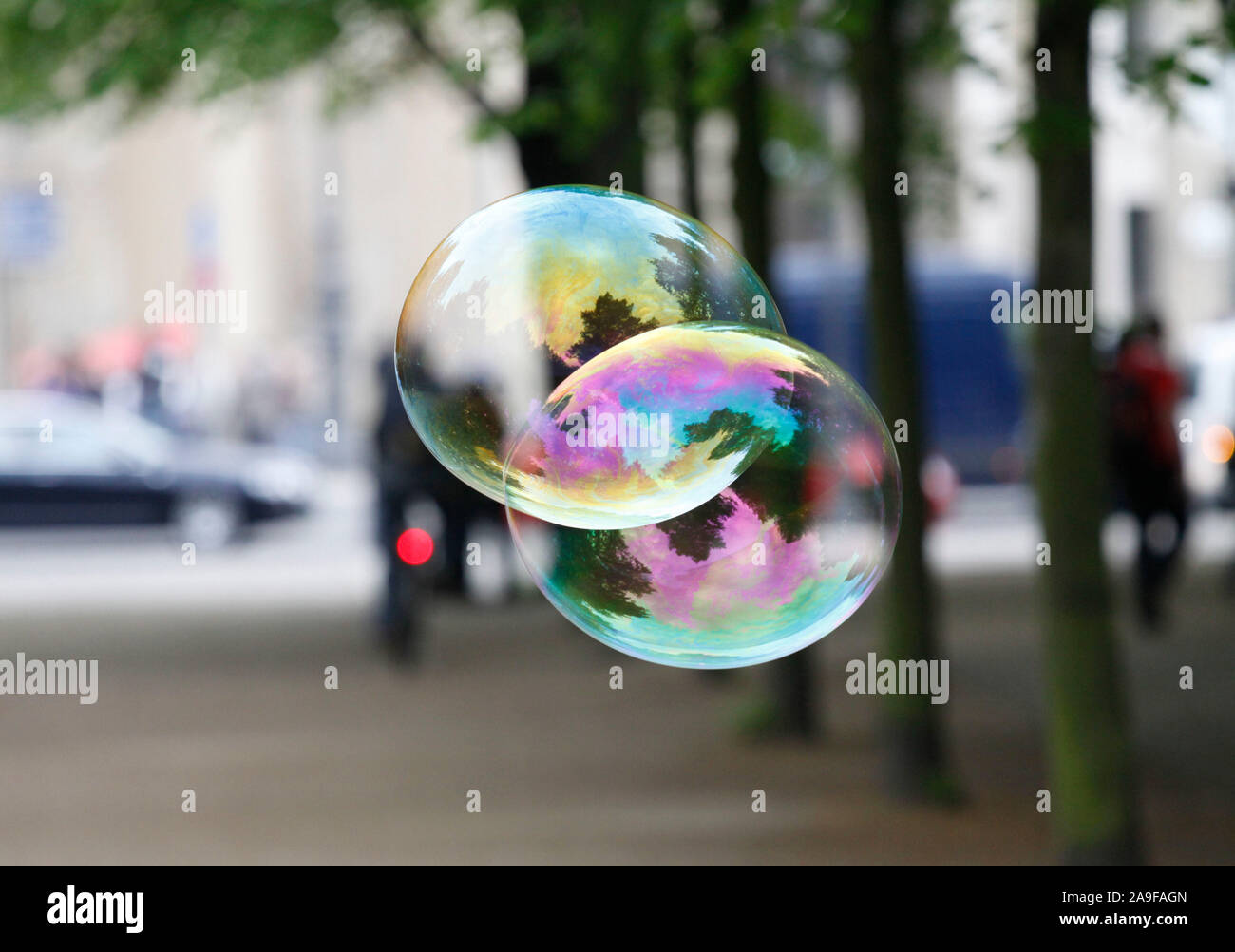 Colourfull twin soap bubble in the town, close up Stock Photo - Alamy