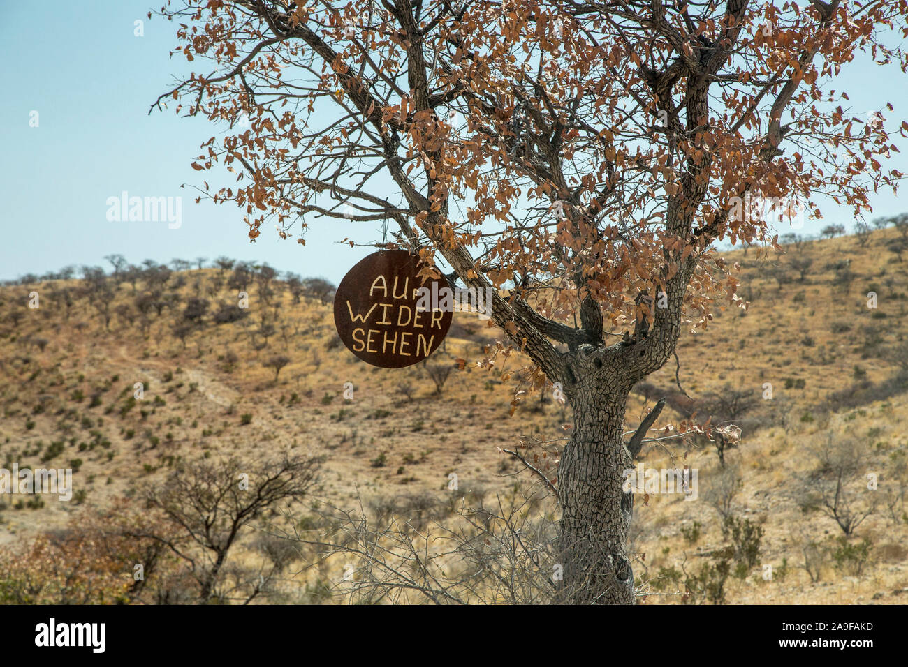 Sign with 'Auf Widersehen' (good bye) in a tree in the Himba country ...