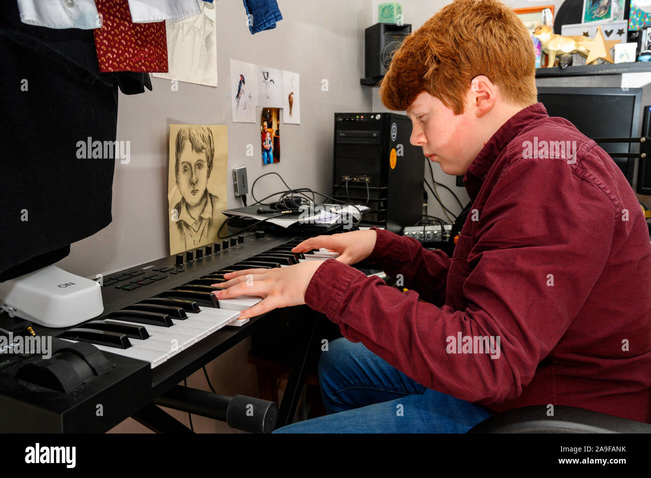 Young boy playing electronic keyboard Stock Photo - Alamy