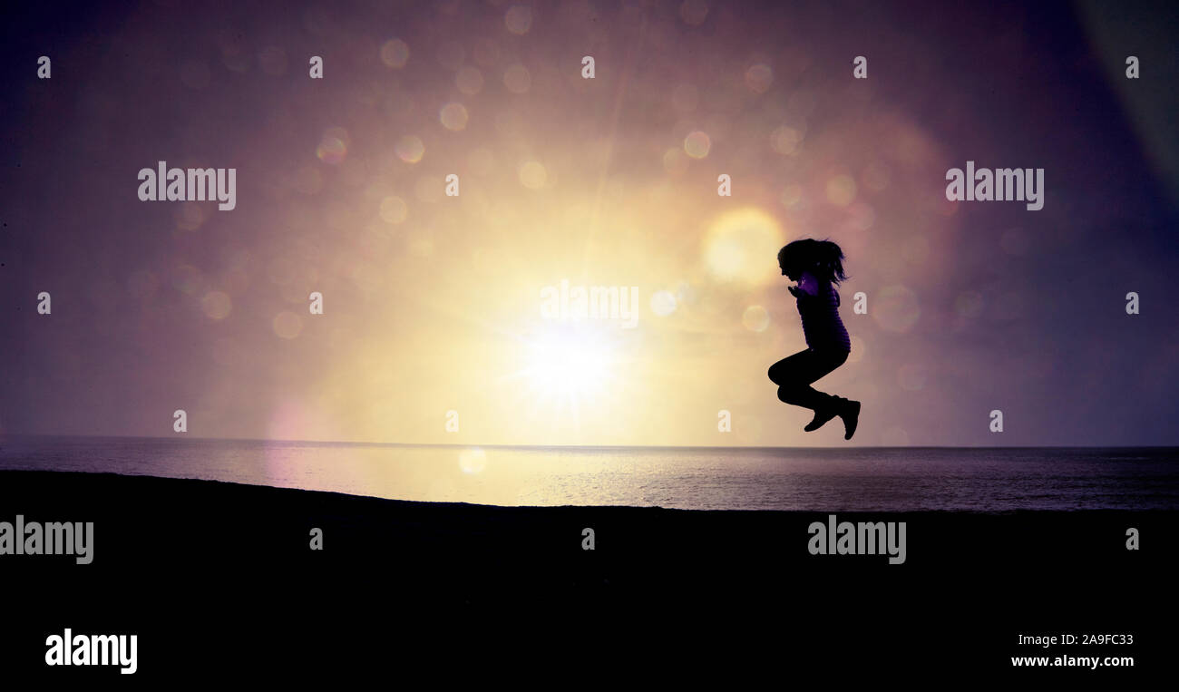 Woman skipping at the beach hi-res stock photography and images - Alamy