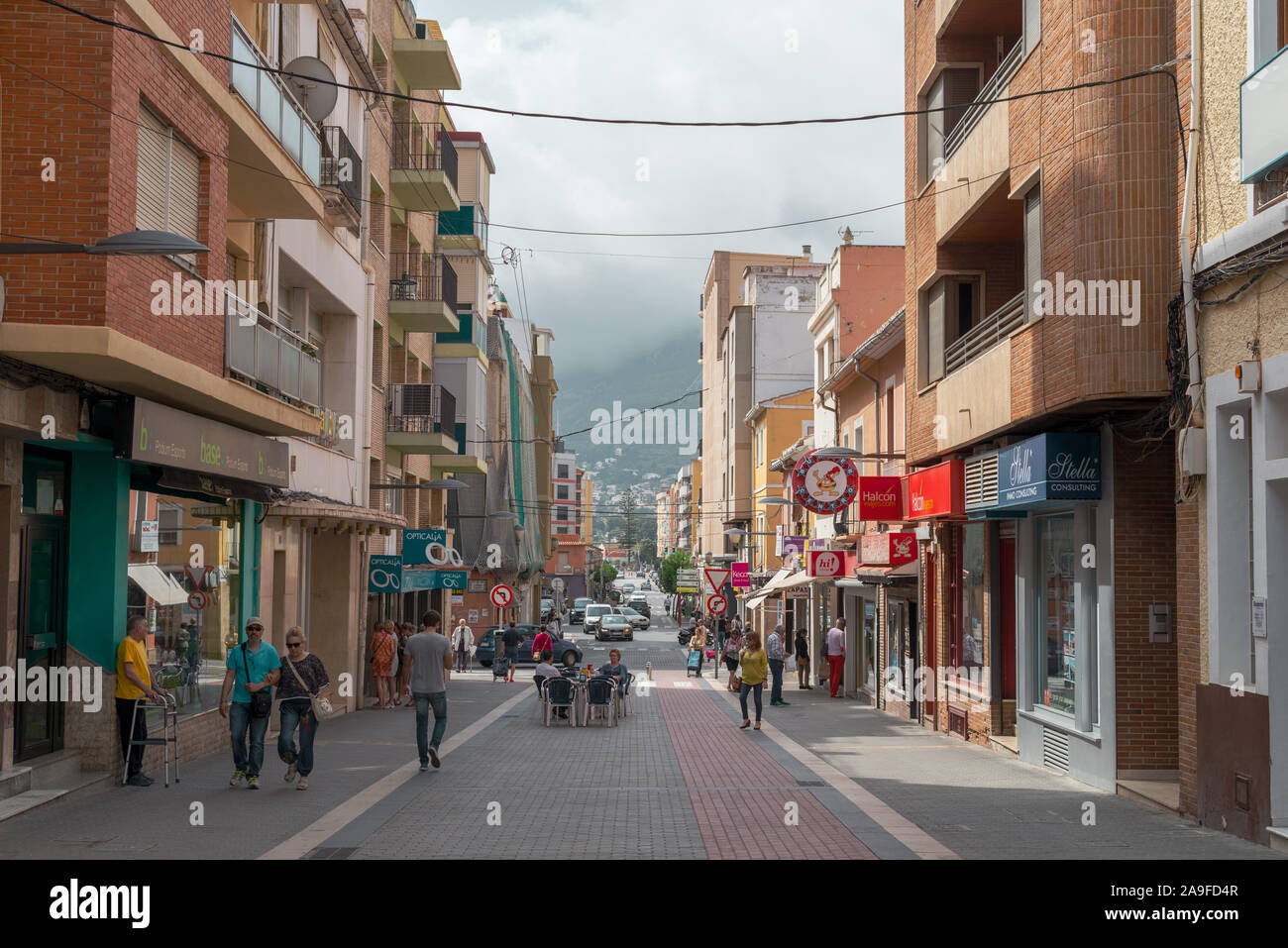 Shops, cafes and bars along a street in Denia, Spain Stock Photo - Alamy