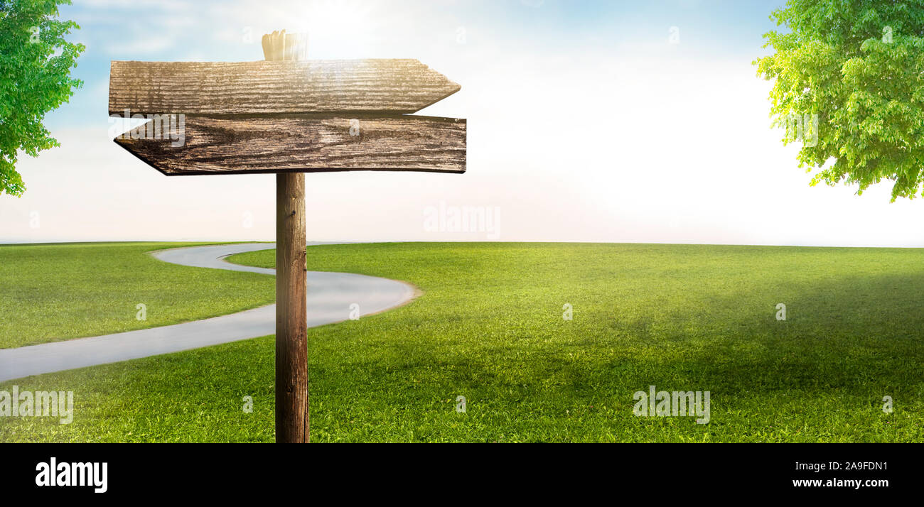 Signpost in landscape with road Stock Photo - Alamy