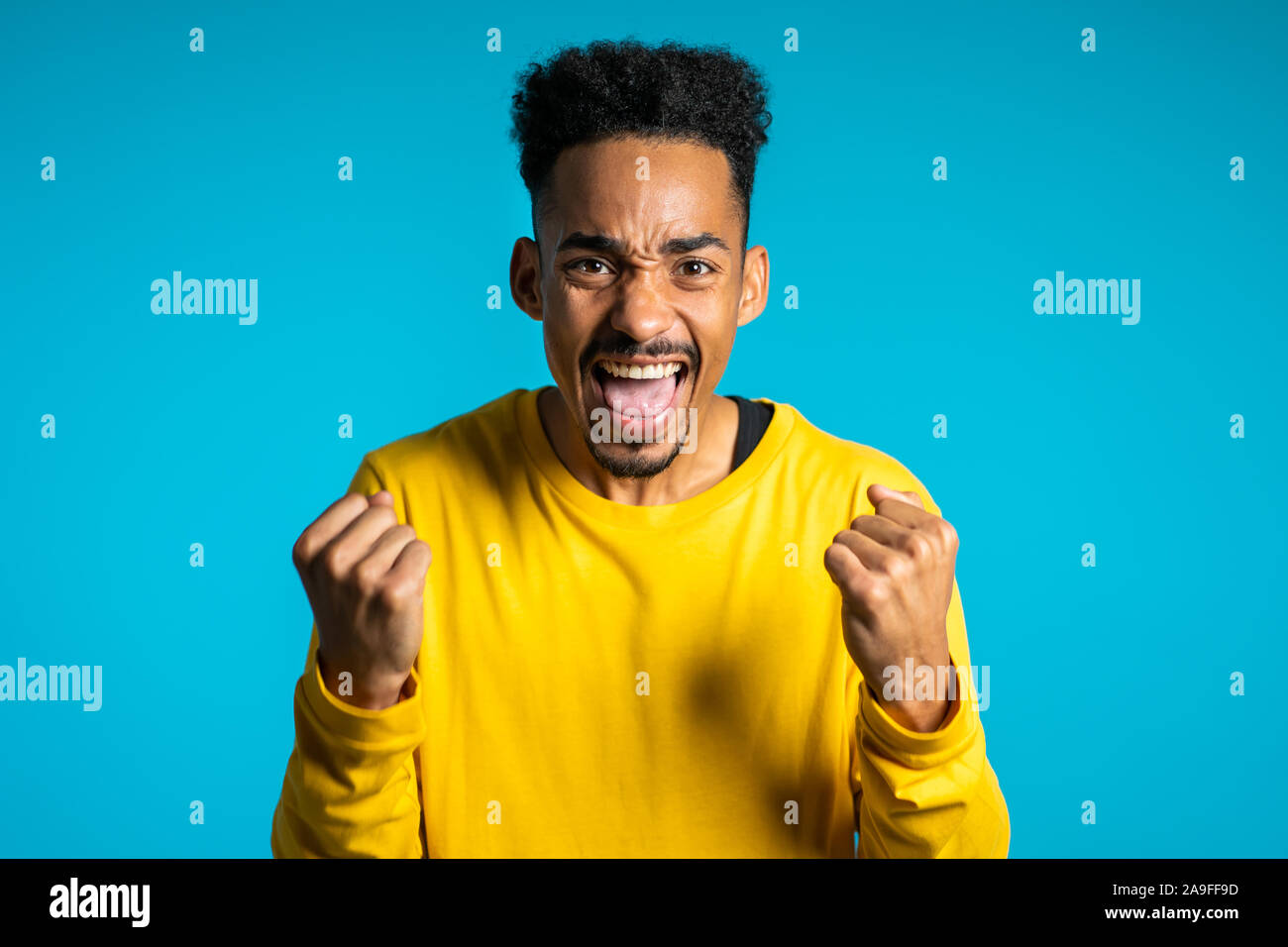 Man shows yeah gesture of victory,he achieved result, goals. Surprised ...