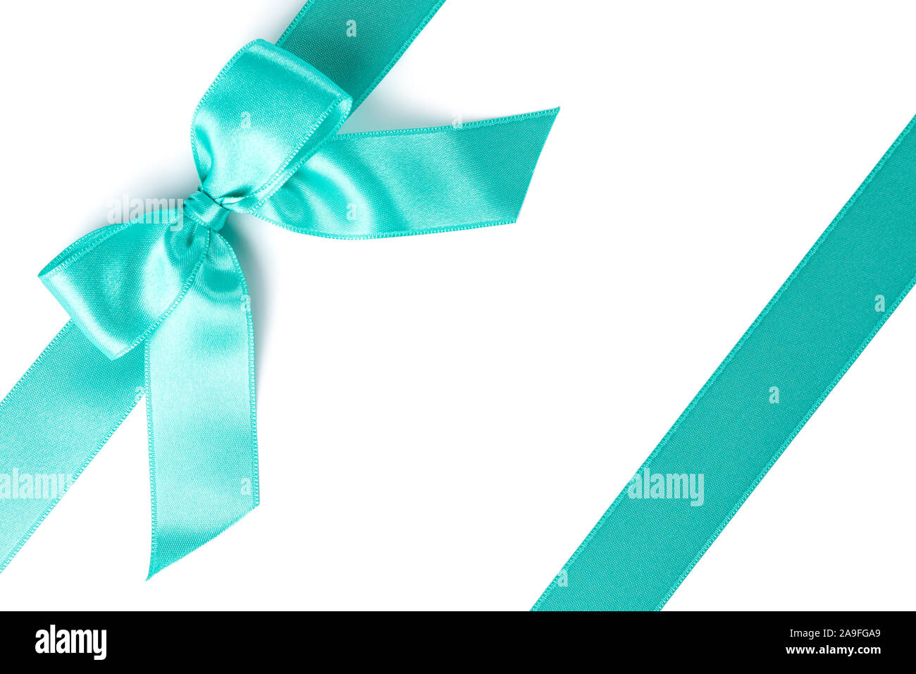 Turquoise ribbons with bow isolated on white background. Gift concept ...