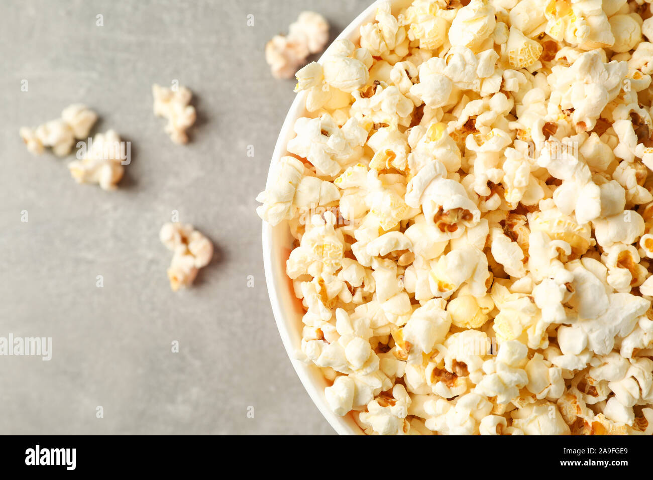 Bucket with popcorn on grey background, space for text Stock Photo - Alamy