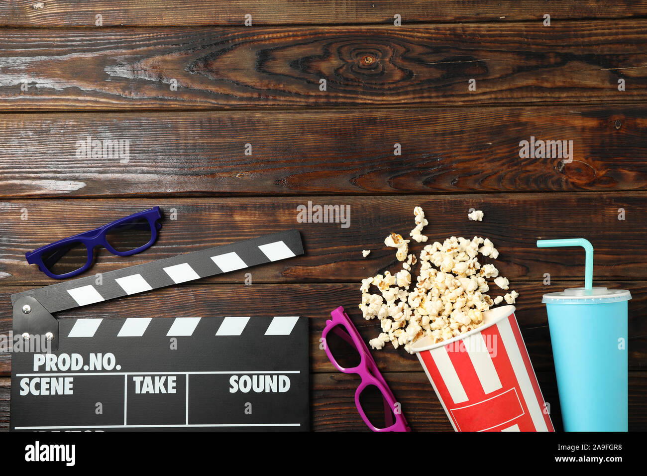 Flat lay. Bucket with popcorn, clapperboard, 3d glasses and drink on ...