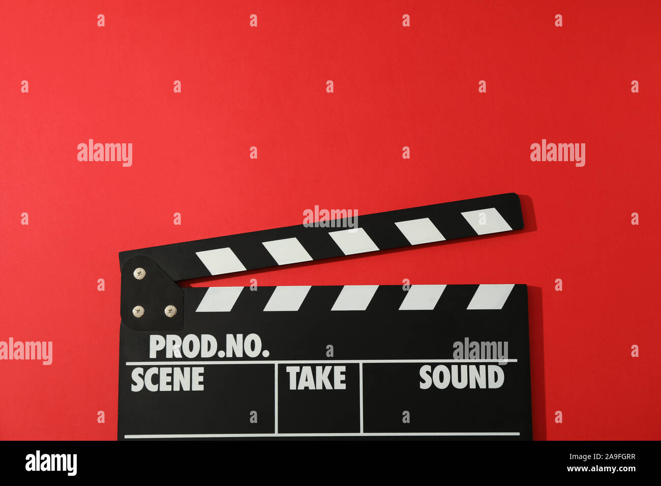 Black clapperboard on red background, space for text Stock Photo - Alamy