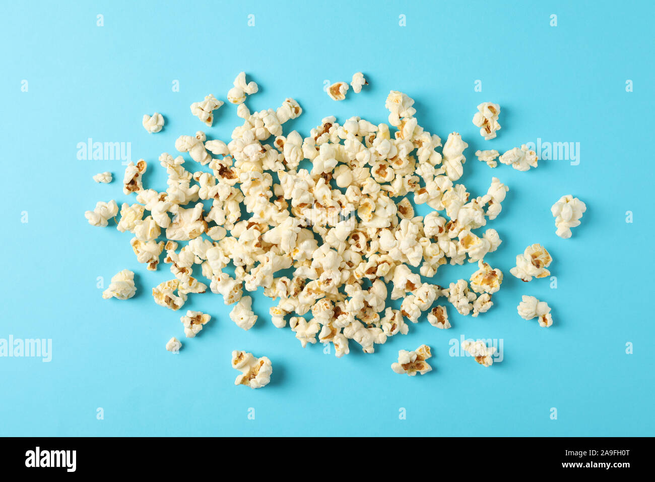 Flat lay composition with popcorn on blue background, copy space Stock ...