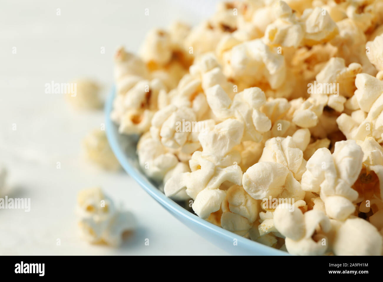 Plate with popcorn on white background, space for text Stock Photo - Alamy