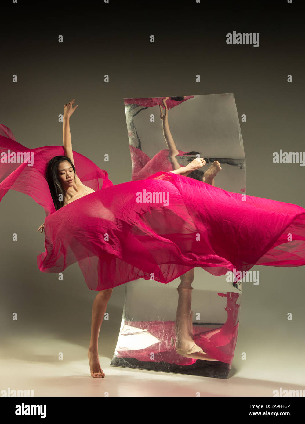 Perfect line. Modern ballet dancer on brown background with mirror ...