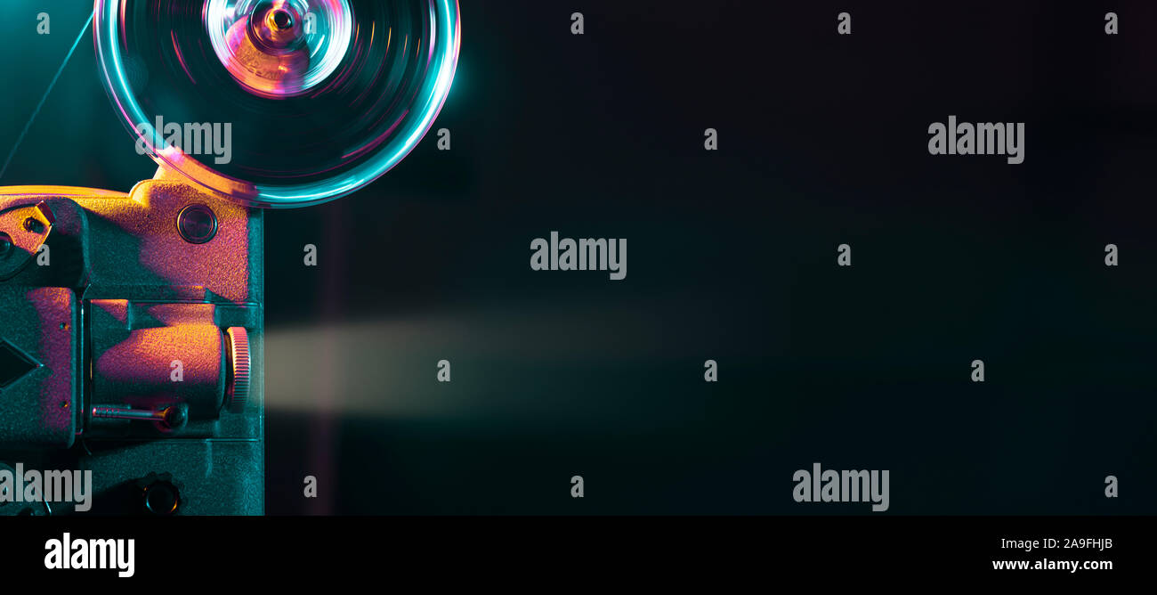 Vintage old fashioned projector in a dark room projecting a film ...