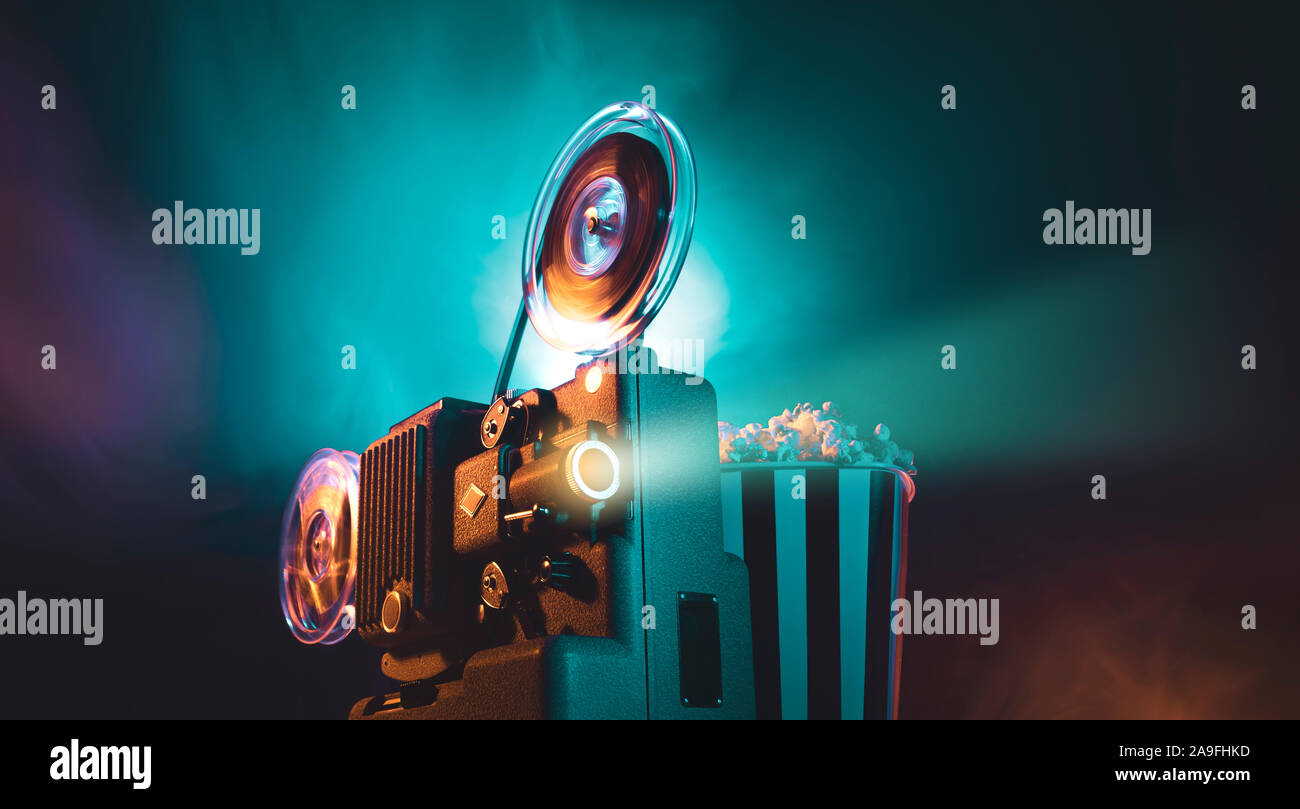 Vintage old fashioned projector in a dark room projecting a film ...