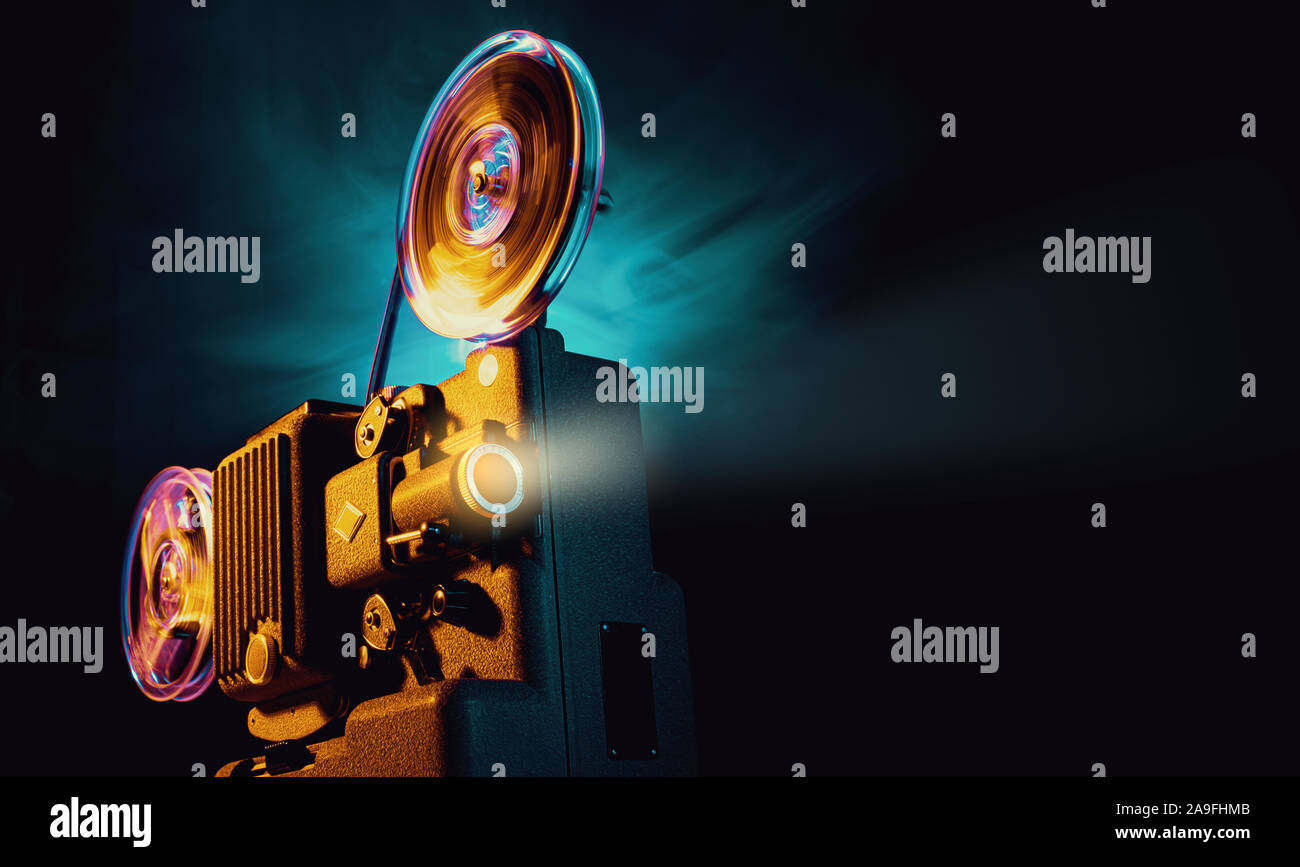 Vintage old fashioned projector in a dark room projecting a film ...