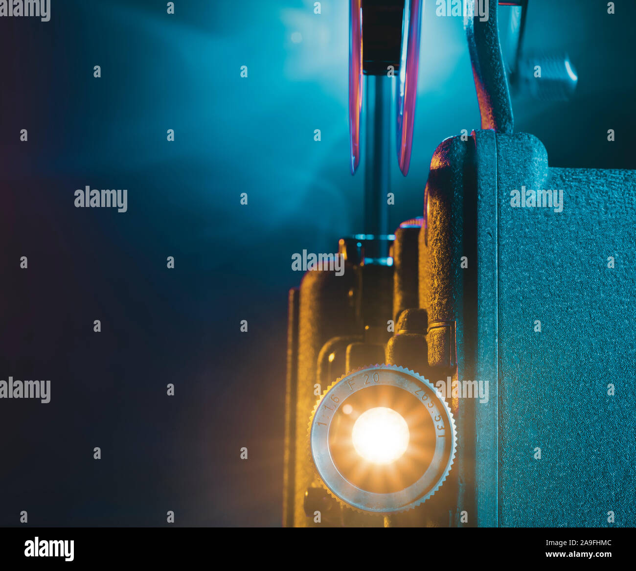 Vintage old fashioned projector in a dark room projecting a film ...