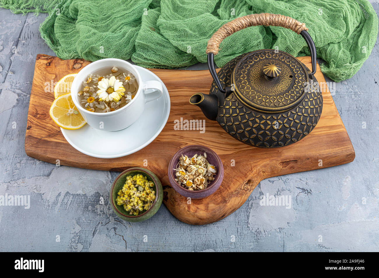 Casting teapot chamomile tea. Oriental cast iron tea pot with tea cup ...