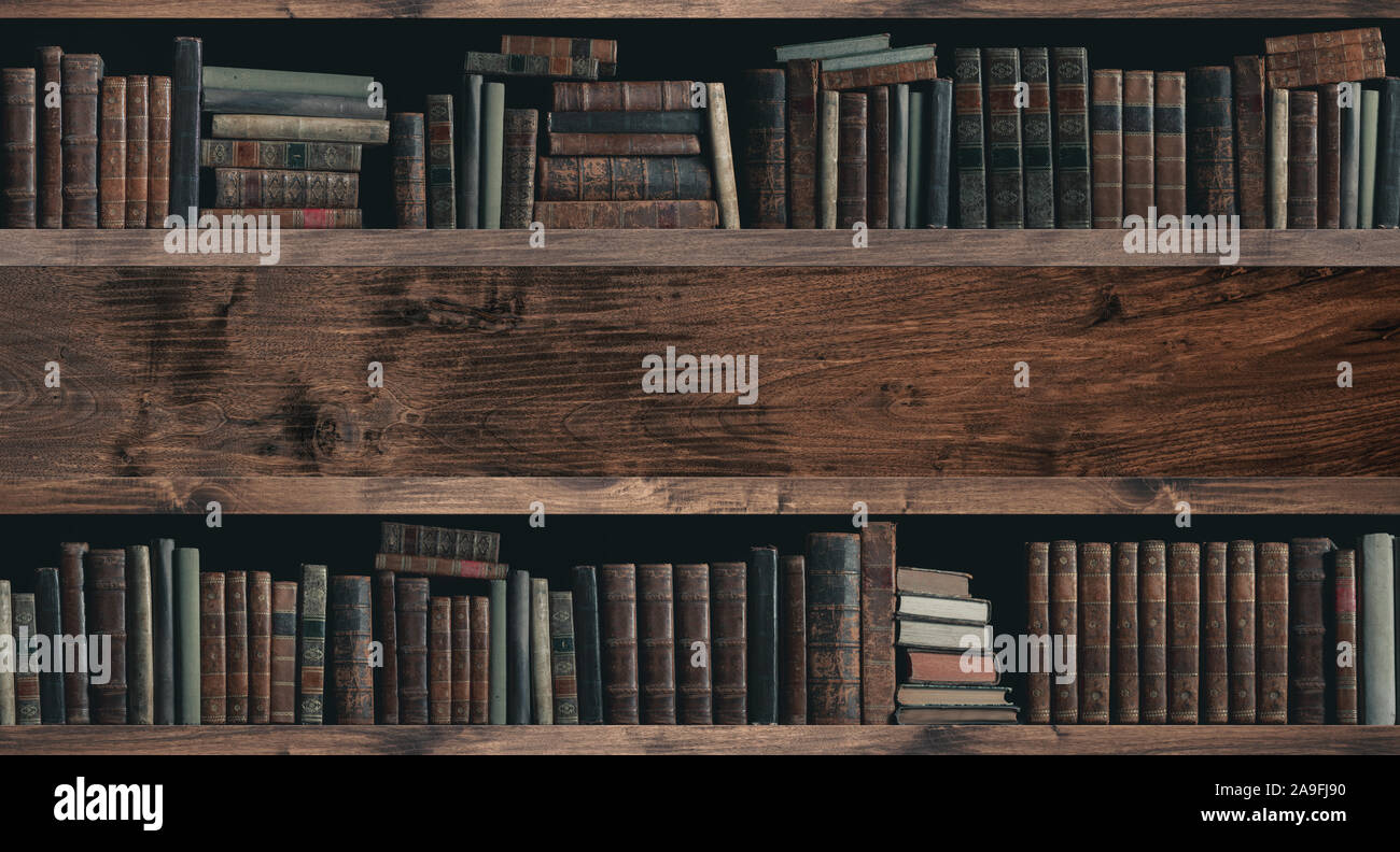 Collection of valuable ancient books on a wooden bookcase: knowledge ...