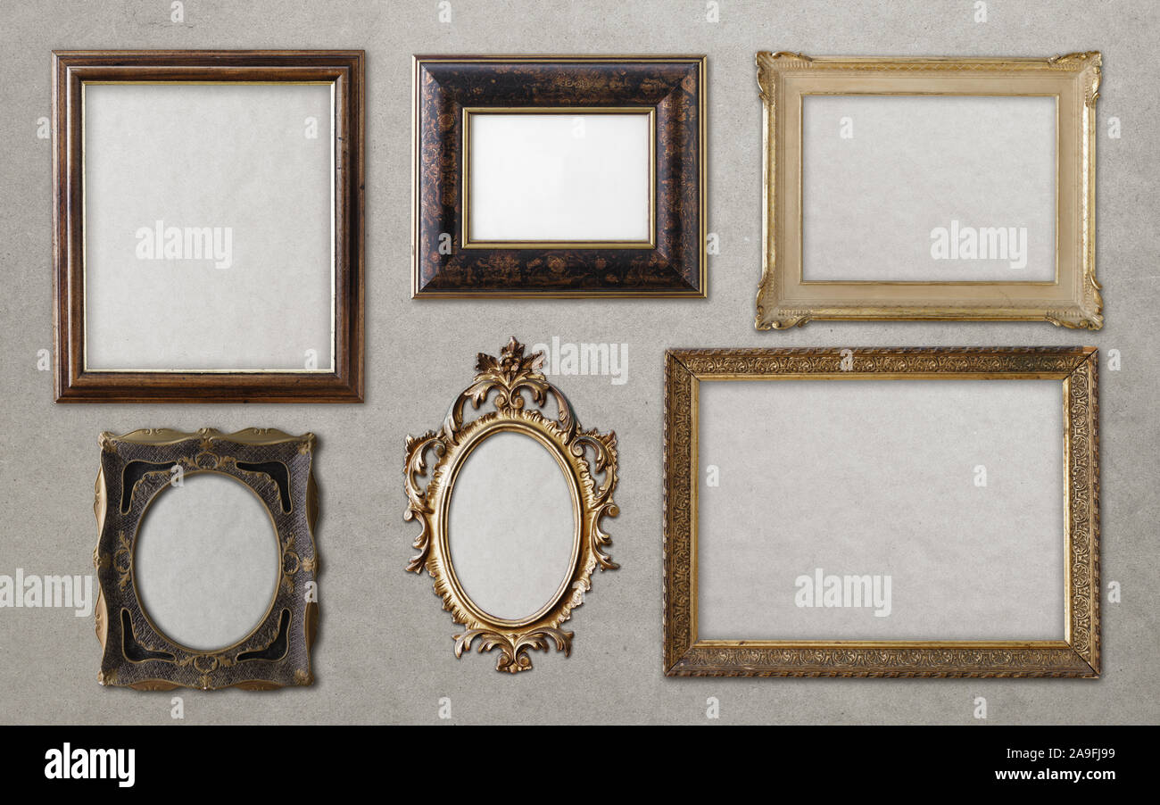 Old empty vintage golden frames hanging on a wall, arts and decoration ...
