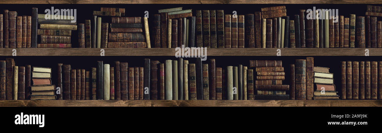 Collection of valuable ancient books on a wooden bookcase: knowledge ...