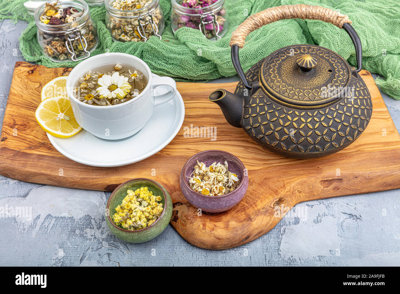Casting teapot chamomile tea. Oriental cast iron tea pot with tea cup ...