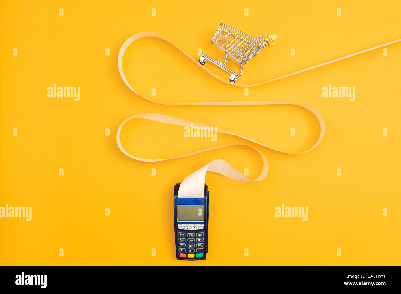 Miniature empty shopping cart on a long POS terminal receipt, expensive ...